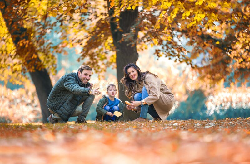 Family Having Fun in the Autumn Park with His Son. Stock Photo - Image ...