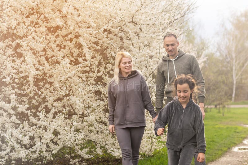 Family Having Fun with Flowering Tree in Blooming Spring Garden Stock ...