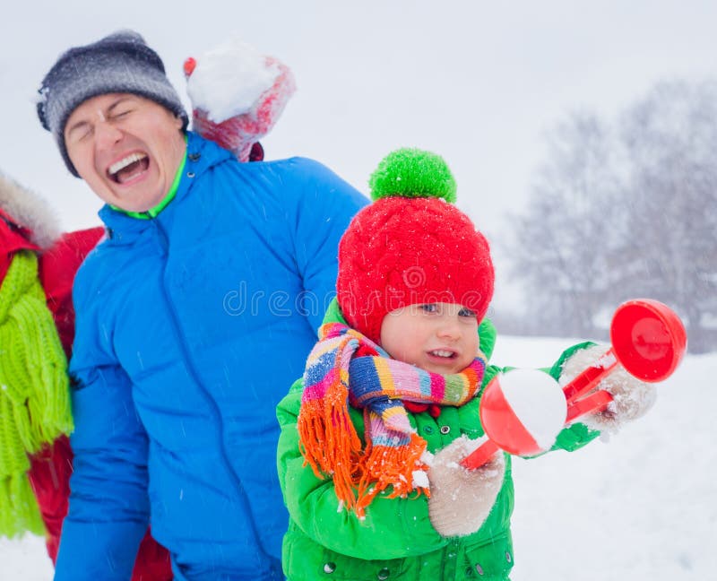 Family having fun in snow stock image. Image of lifestyle - 63757279