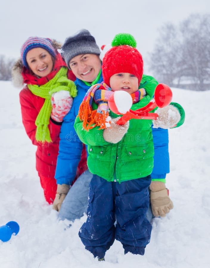 Family having fun in snow stock image. Image of lifestyle - 63757279