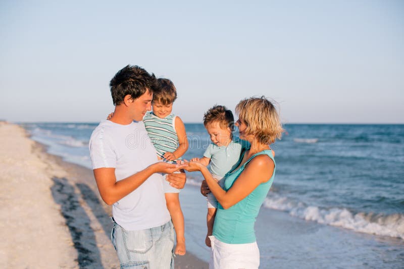 Family Having Fun on Tropical Beach Stock Image - Image of holding ...