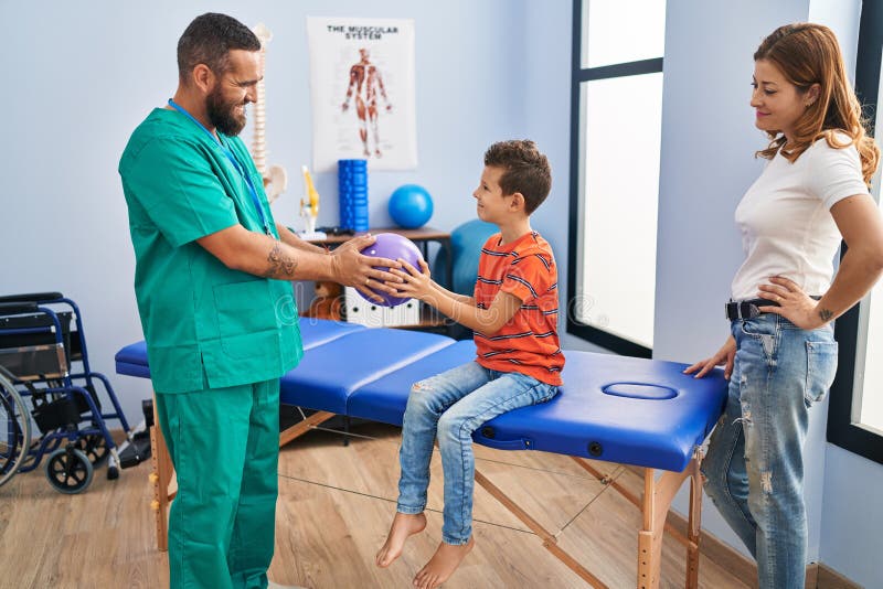 Family Having Rehab Session Using Ball at Rehab Clinic Stock Photo ...