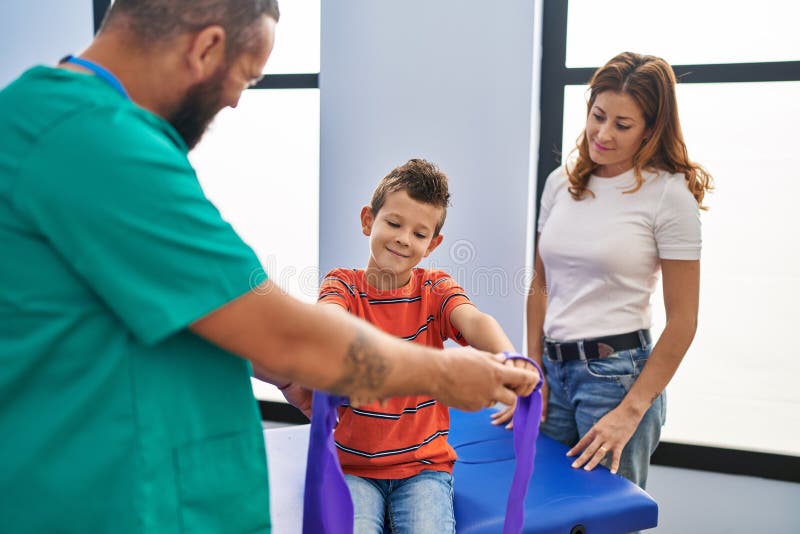 Family Having Rehab Session Using Elastic Band at Rehab Clinic Stock ...