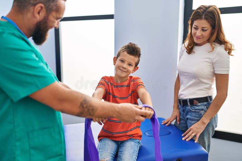 Family Having Rehab Session Using Elastic Band at Rehab Clinic Stock ...