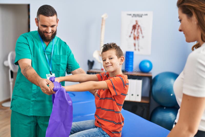 Family Having Rehab Session Using Elastic Band at Rehab Clinic Stock ...