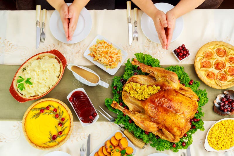 Family Holding Hands Over Table Setting and Praying Stock Photo - Image ...