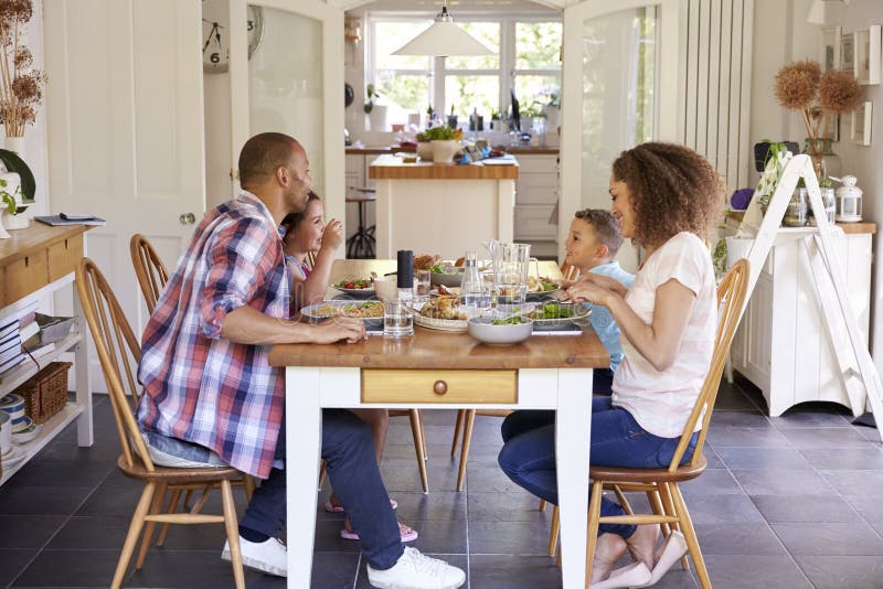 Family at Home Eating Meal in Kitchen Together Stock Photo - Image of ...