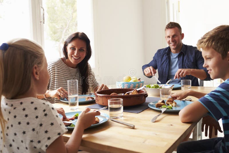 Family at Home in Eating Meal Together Stock Photo - Image of family ...