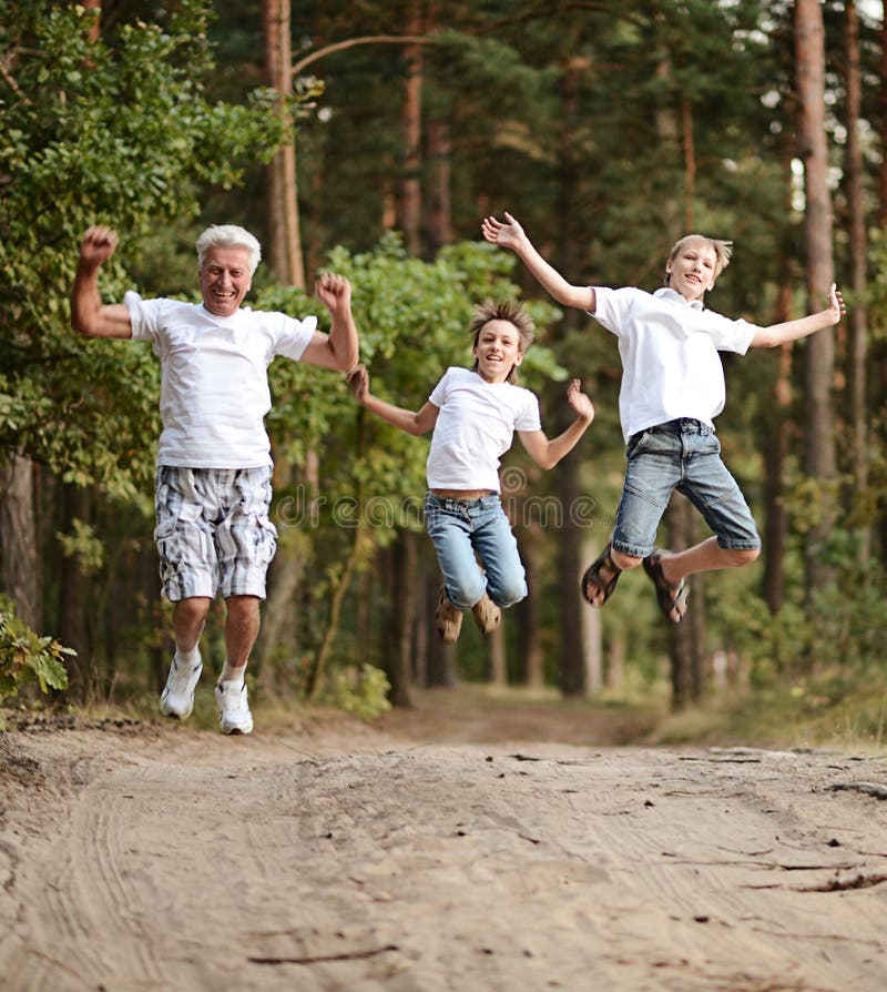 Family jumping in park stock photo. Image of adult, family - 45529778
