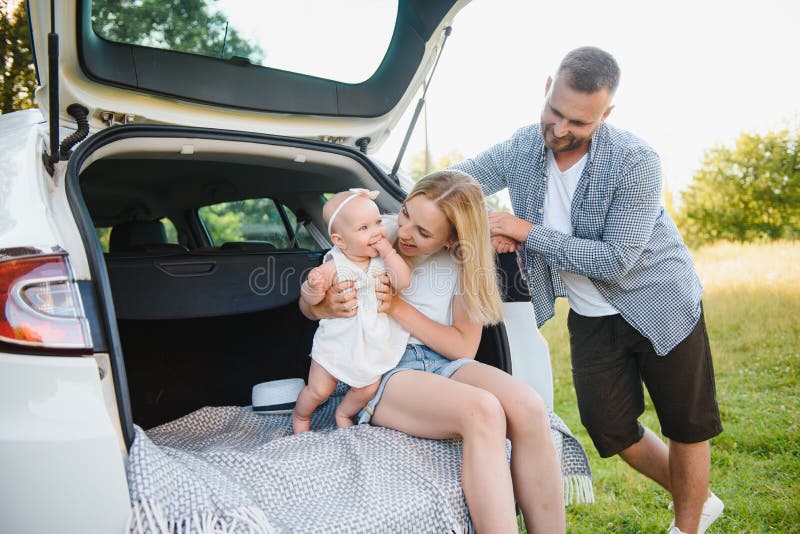 Family with Kid Sitting in Car Trunk Stock Photo - Image of little ...