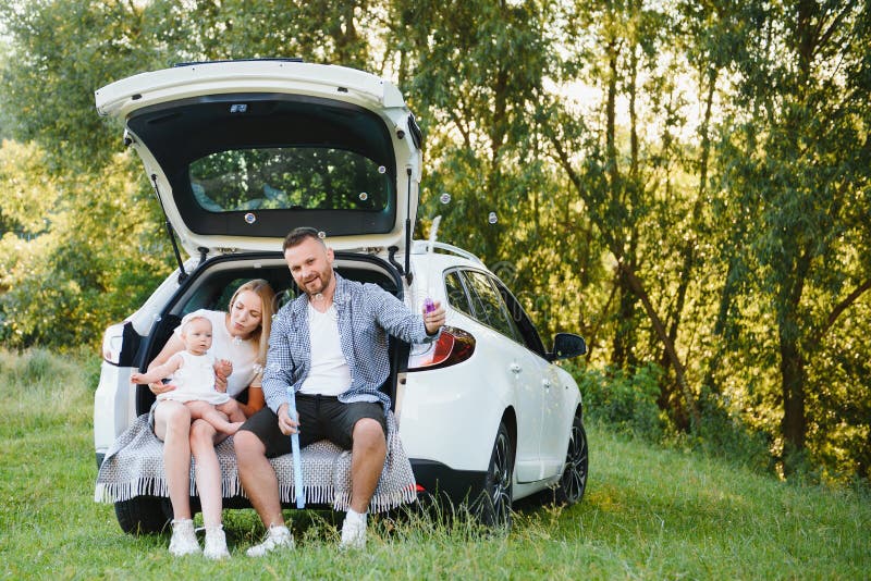 Family with Kid Sitting in Car Trunk Stock Photo - Image of trunk ...