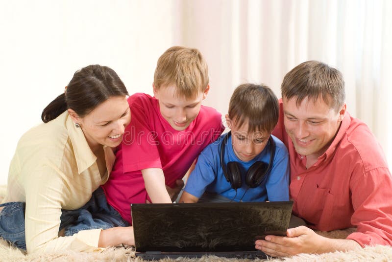 Family at Home Using a Laptop with Thumbs Up Stock Image - Image of ...