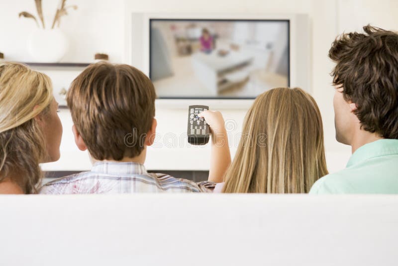 Family Sitting in Living Room with Remote Control Stock Photo - Image ...