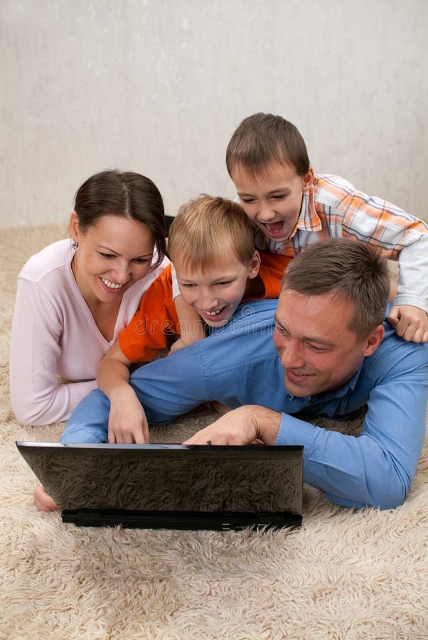 Family looking at laptop stock image. Image of home, brothers - 11833621