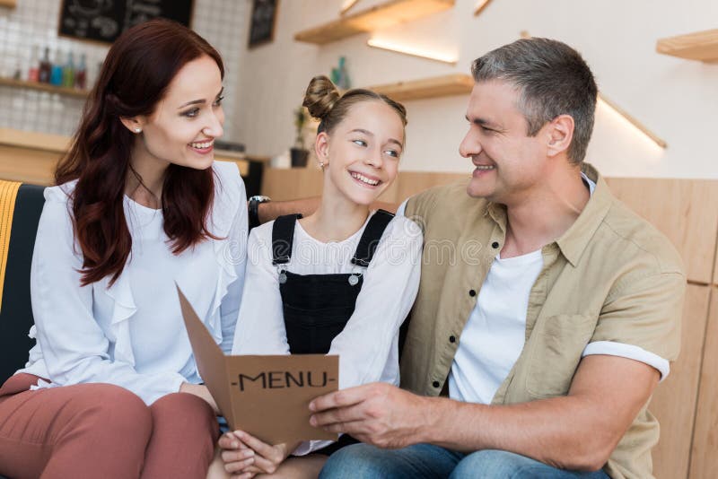 Family Looking at Menu List in Cafe Stock Photo - Image of cafe ...