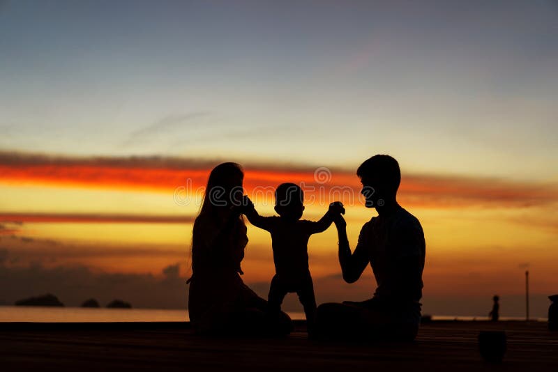 .Family in Love with Son Hugging at Sunset, Silhouette Stock Image ...