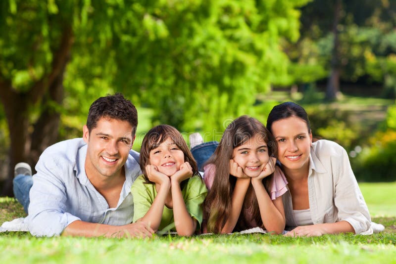 Family Lying Down in the Park Stock Image - Image of family, garden ...