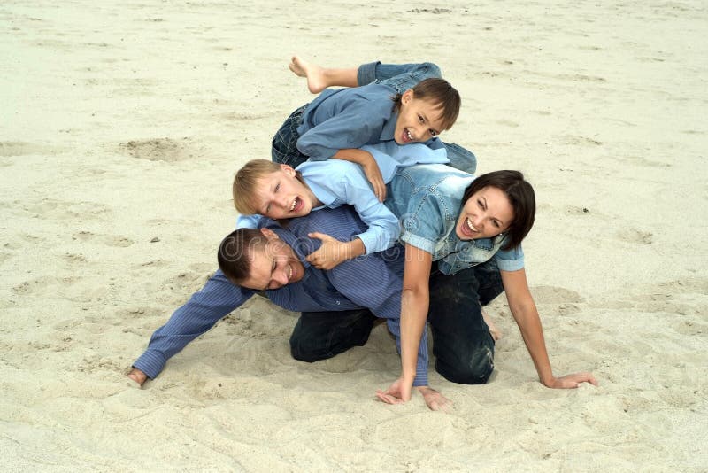 Family lying on the sand stock photo. Image of health - 27601270