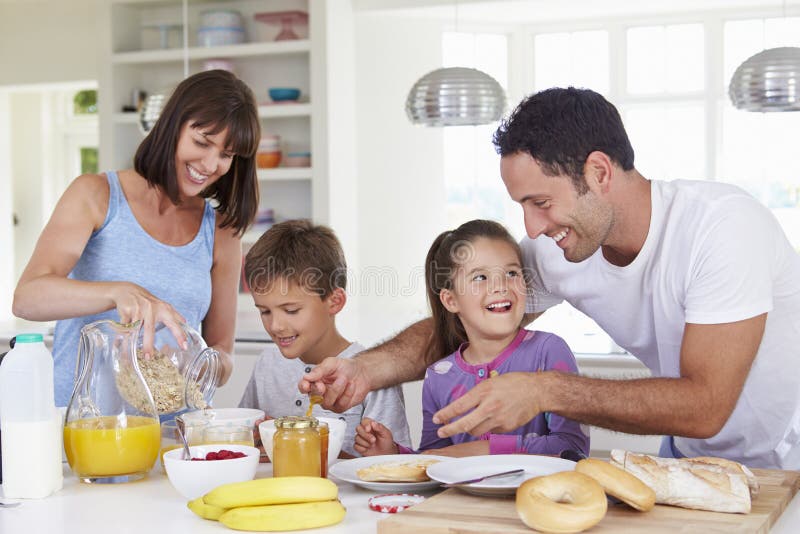 Family Making Breakfast in Kitchen Together Stock Photo - Image of ...