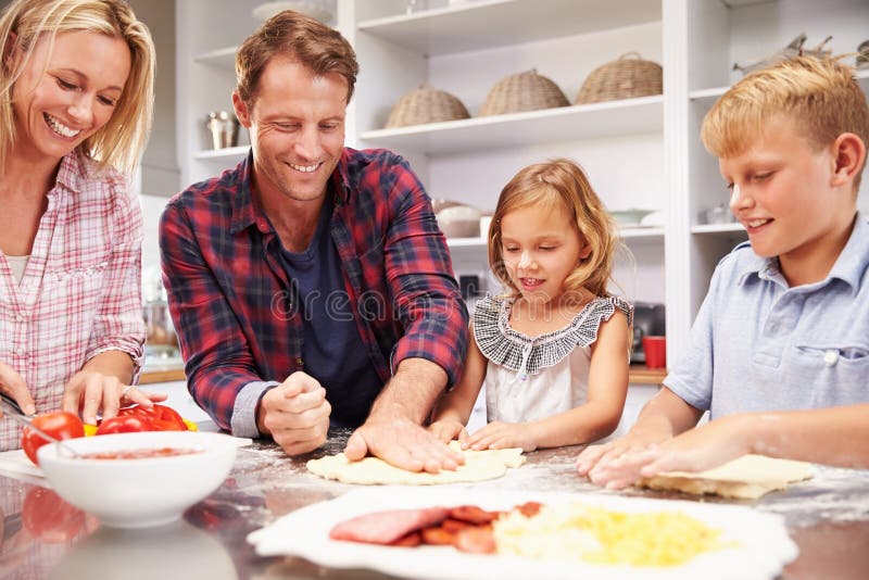 Family Making Pizza Together Stock Photo - Image of cooperation ...