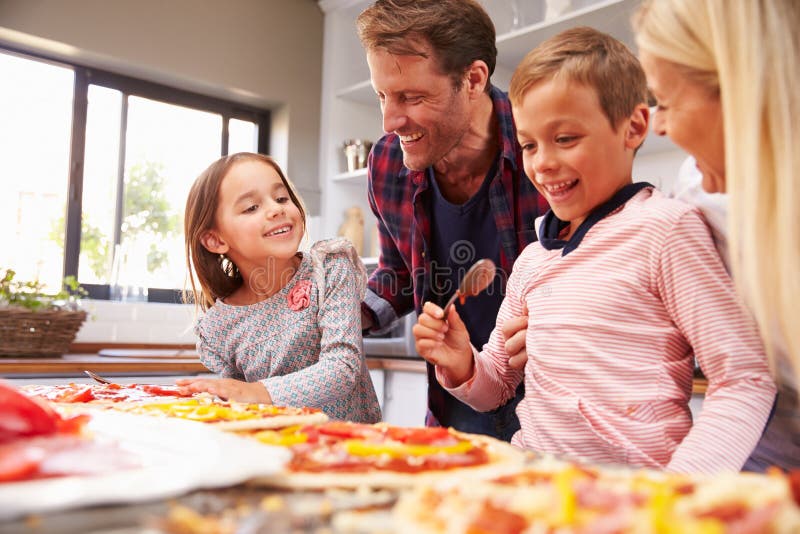 Family Making Pizza Together Stock Photo - Image of cooperation ...