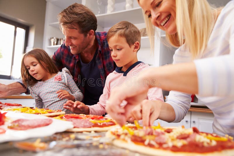 Family Making Pizza Together Stock Photo - Image of horizontal, four ...