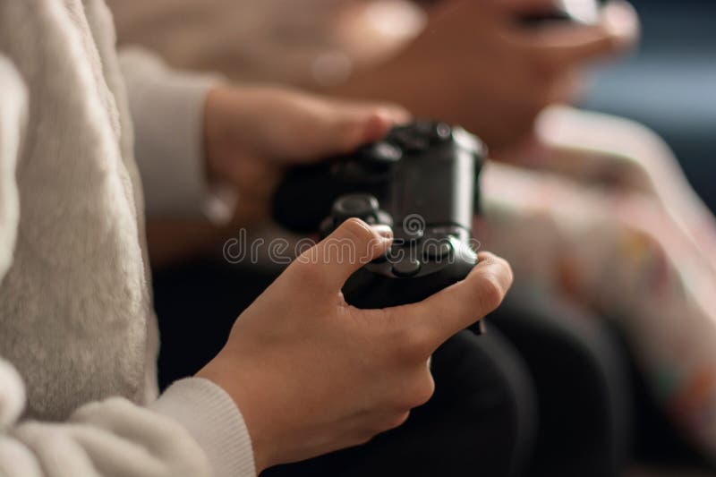 Family Members Holding Game Controllers in Their Hands Stock Photo ...