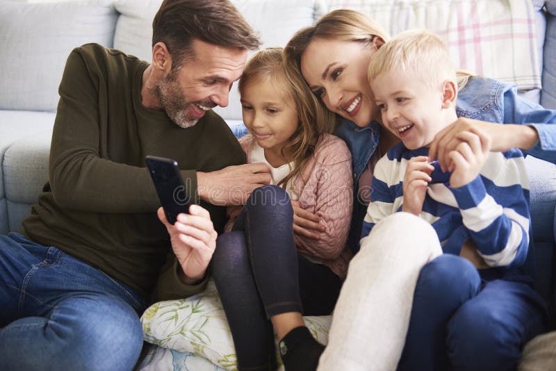 Family using mobile phone stock image. Image of interior - 172213511