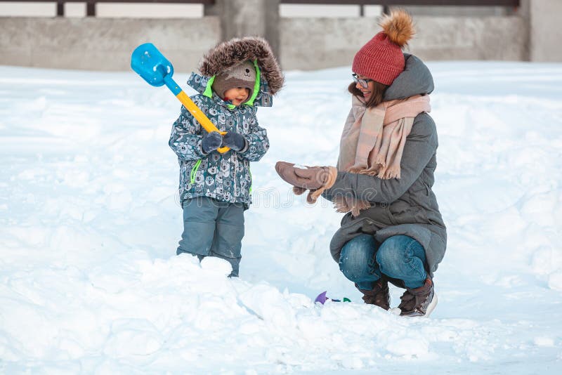 Family Mom and Child Winter Activity Having Fun Together in Snow Stock ...