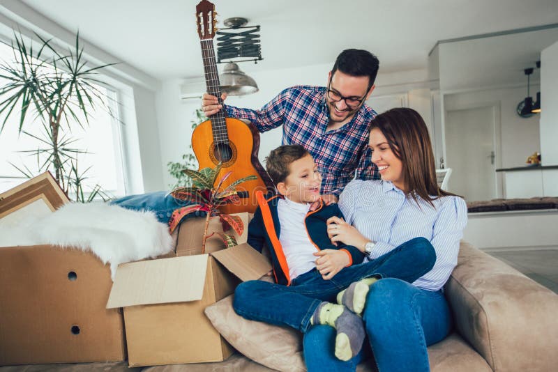 Family Moving Home with Boxes Around, and Having Fun Stock Photo ...