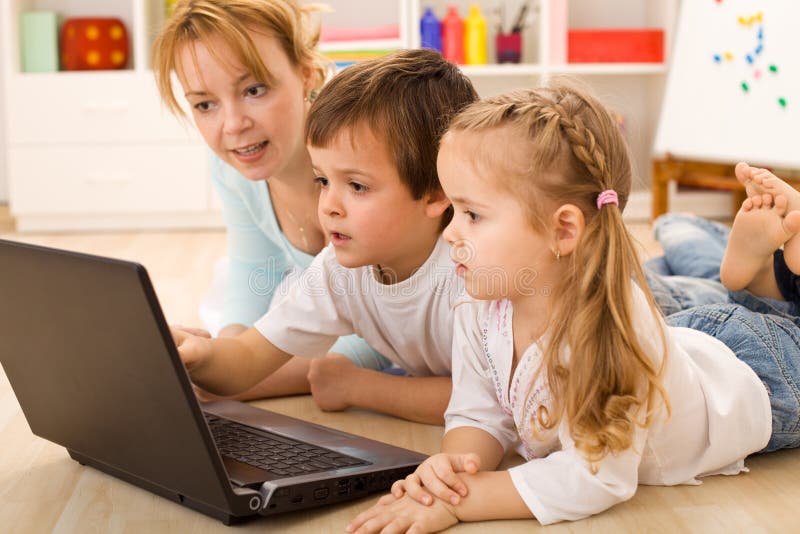Thoughtful Mother with Laptop and Kids with Tablet Computers Stock ...