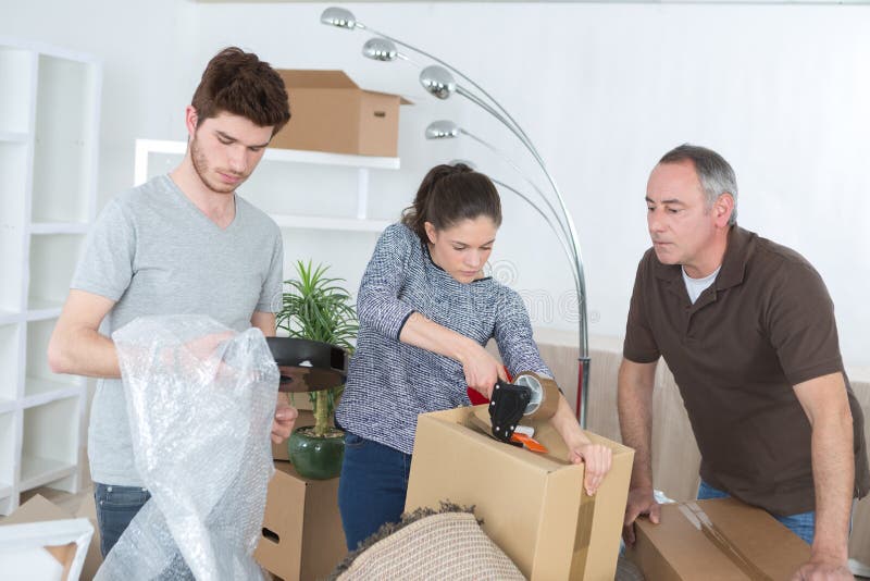 Family Packing Cardboard Boxes in Living Room Stock Photo - Image of ...