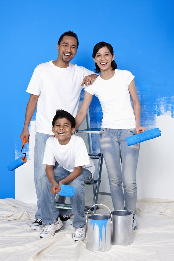Family with Paint Rollers Getting Ready To Paint the Wall. Conceptual ...