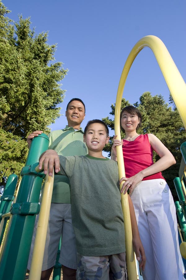 Family on Playground Smiling - Vertical Stock Image - Image of smiling ...