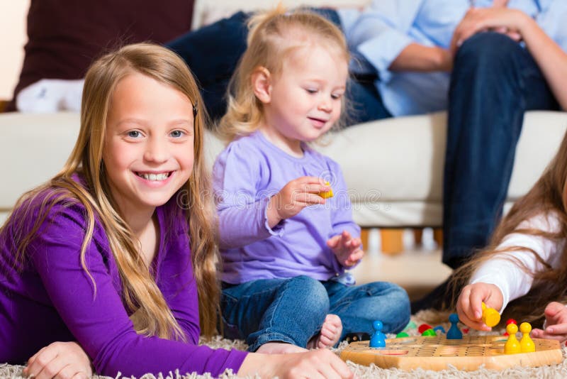 Family Playing Board Game at Home Stock Photo - Image of board, parents ...