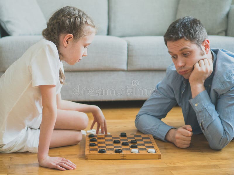 Family playing checkers. stock image. Image of draughts - 110928867