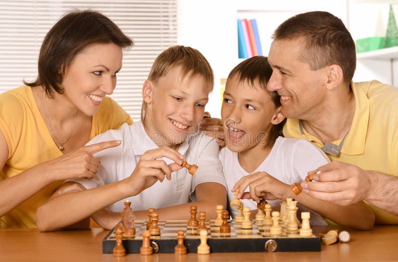 Family playing chess stock image. Image of caucasian - 44346037