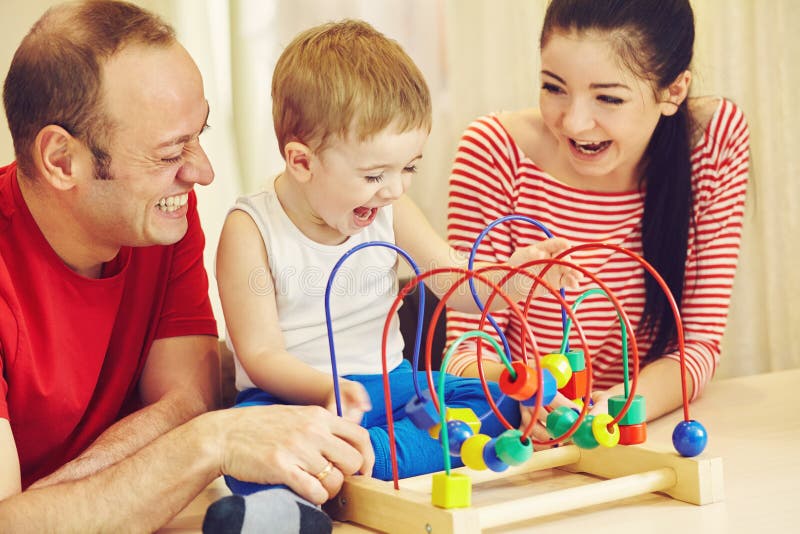 Family Playing in Developing Game. Dad, Mom and Son Having Fun Stock ...