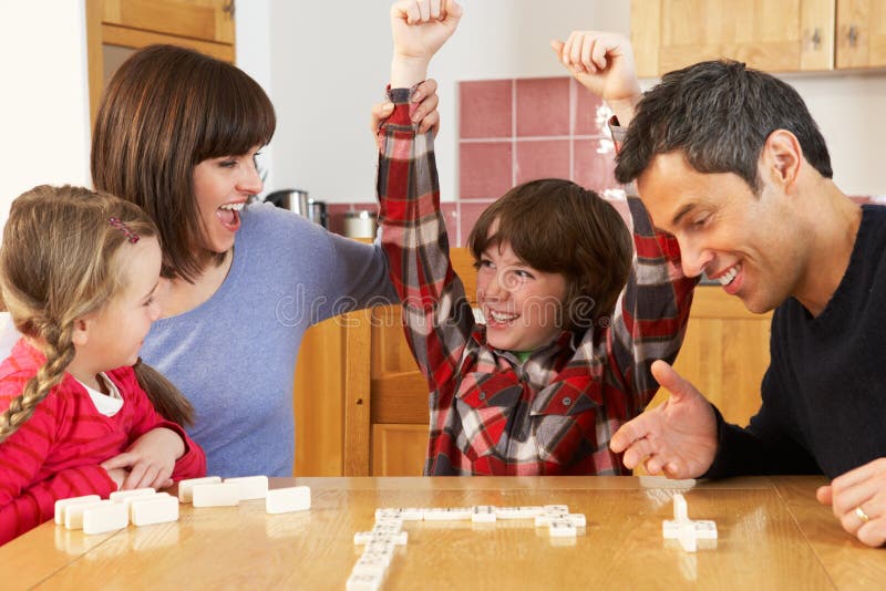 Family Playing Dominoes in Kitchen Stock Image - Image of family ...