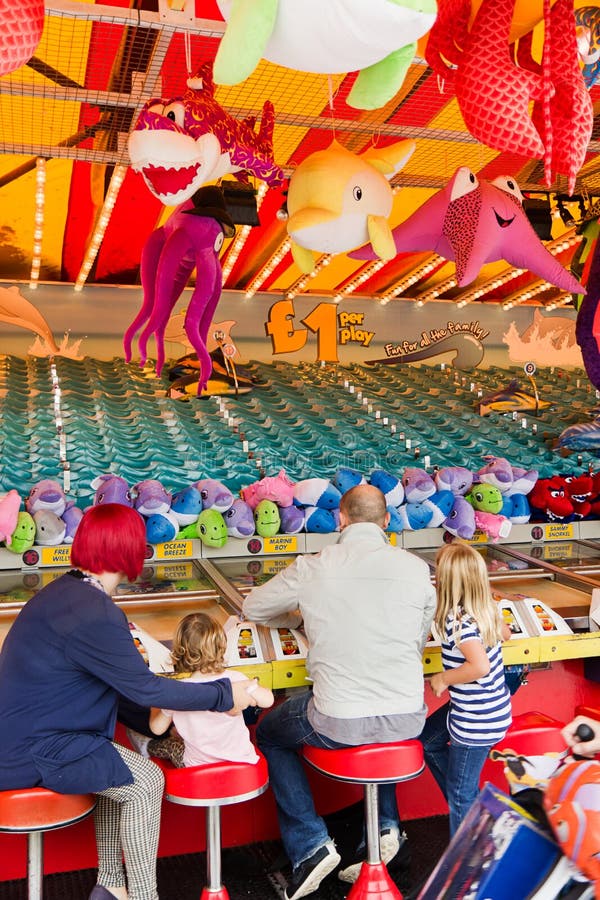 Family Playing a Fairground Game Together Editorial Image - Image of ...
