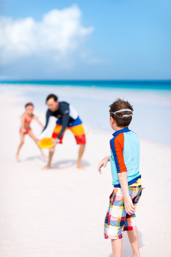Family Playing with Flying Disk Stock Photo - Image of beach, shore ...