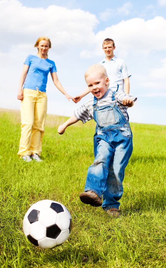 Happy Family Playing Football in Their Backyard Stock Photo - Image of ...