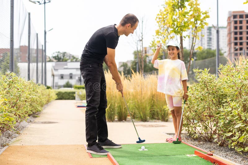 Family Playing Miniature Golf Outdoors Stock Photo - Image of child ...