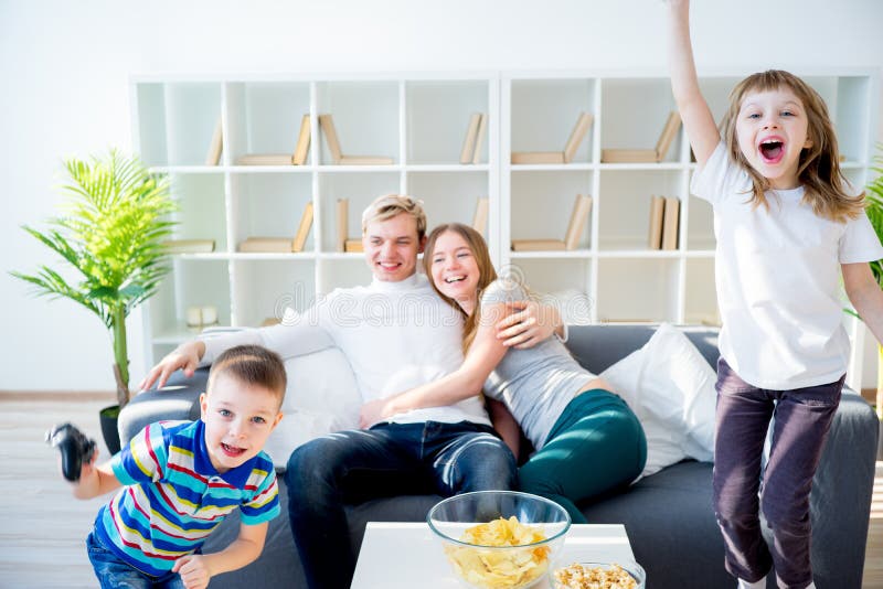 Family playing playstation stock image. Image of couch - 90365335