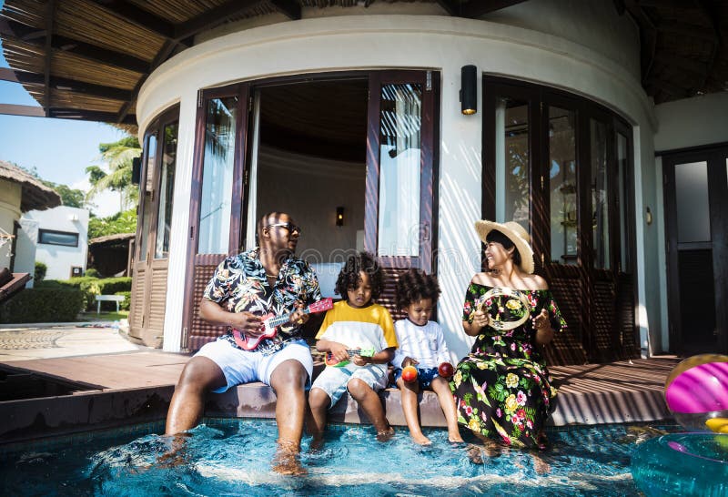 Family playing in a pool stock photo. Image of hotel - 118202268