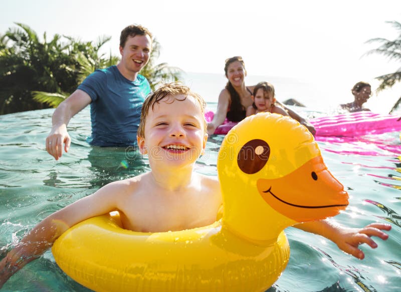 Family playing in a pool stock photo. Image of lifestyle - 123368248