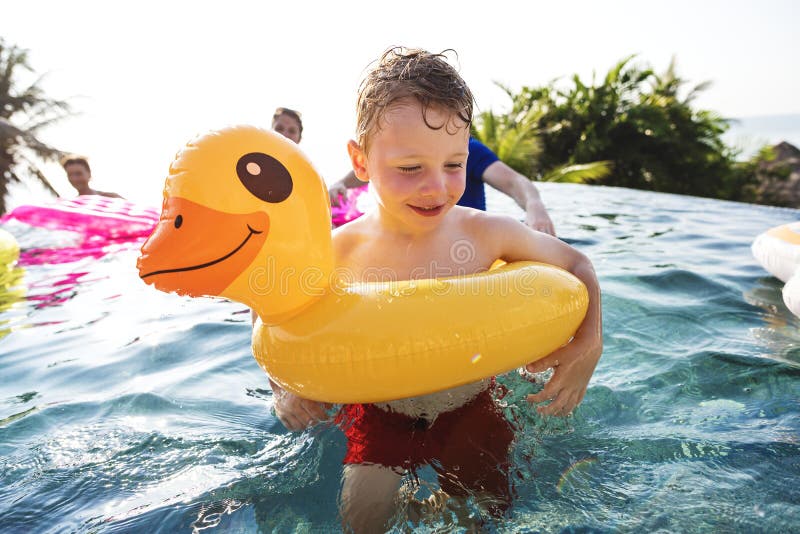 Family playing in a pool stock image. Image of activity - 218588027
