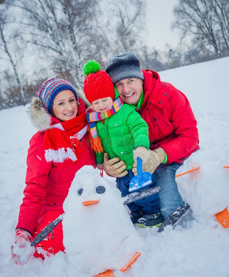 Family playing snow stock image. Image of cold, beautiful - 63484475