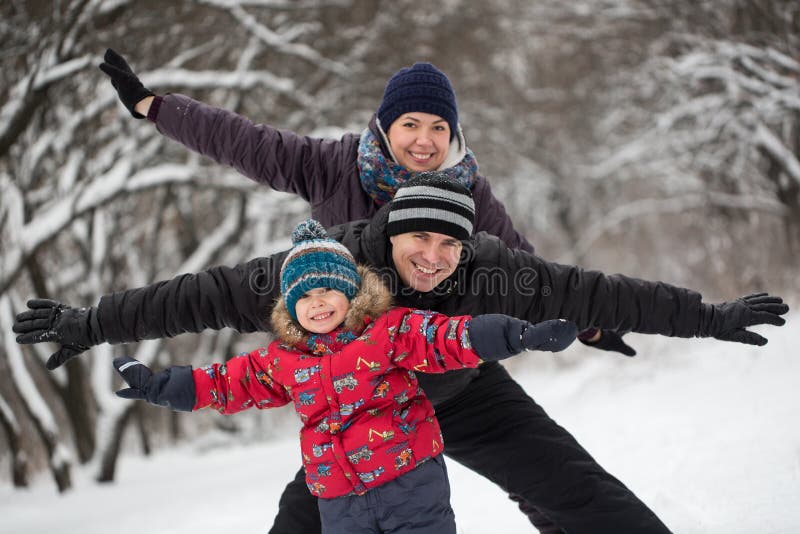Family Playing in the Snow in Winter. Stock Image - Image of father ...