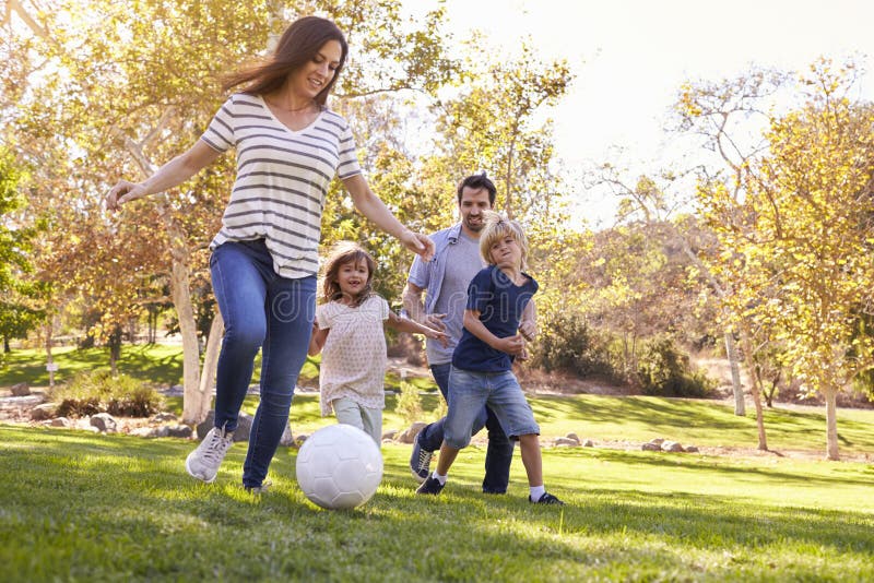 Family Playing Soccer in Park Together Stock Image - Image of helping ...